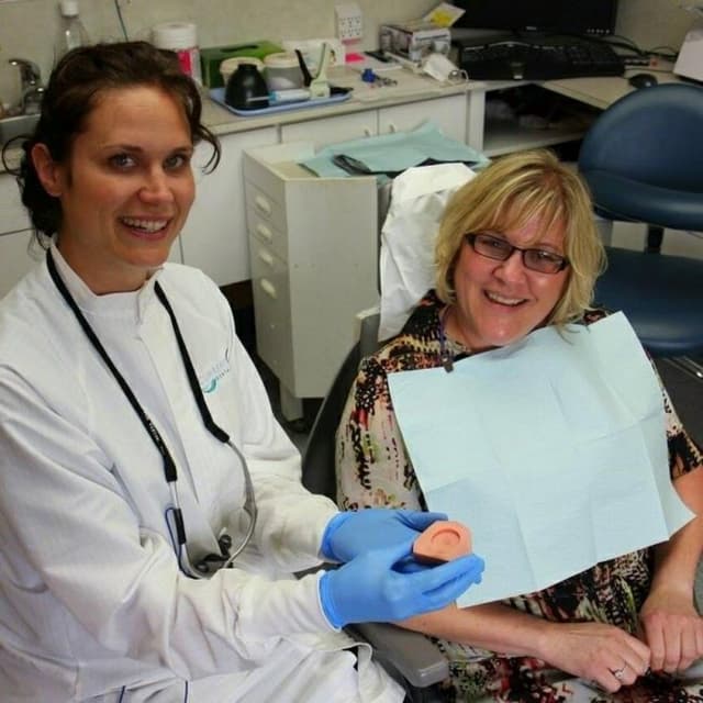 Dr. Melissa Spaulding DDS explaining a dental procedure to her patient ...