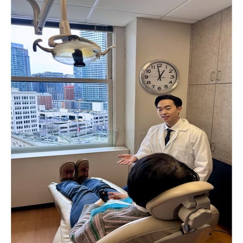 Dr. Harry Shin explaining dental crown procedure to patient at Moritis ...