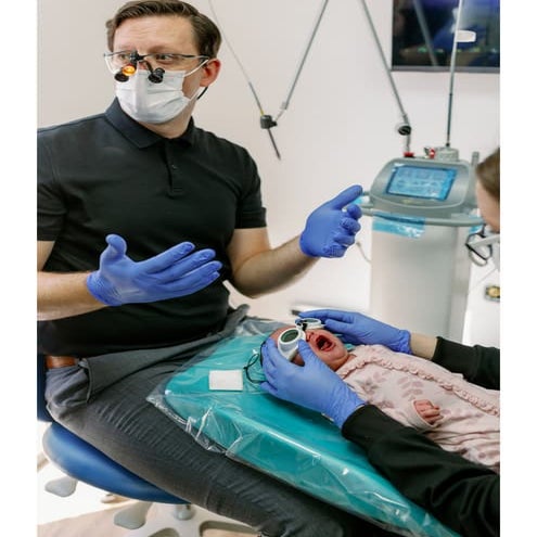 Pediatric dentist Justin Warcup working on patient at North Texas ...