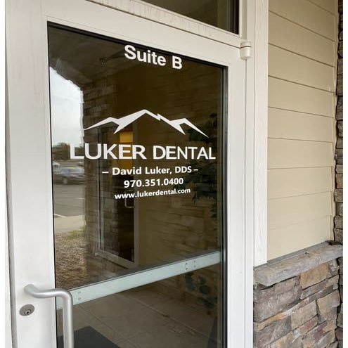 Signage on the glass page on the front door of Greeley dentist Luker ...