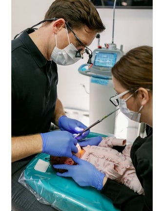 Pediatric dentist Justin Warcup working on patient at North Texas ...